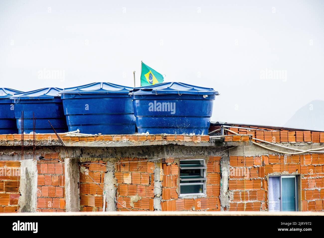 water tank on top of a house with the flag of brazil on the hill of ...