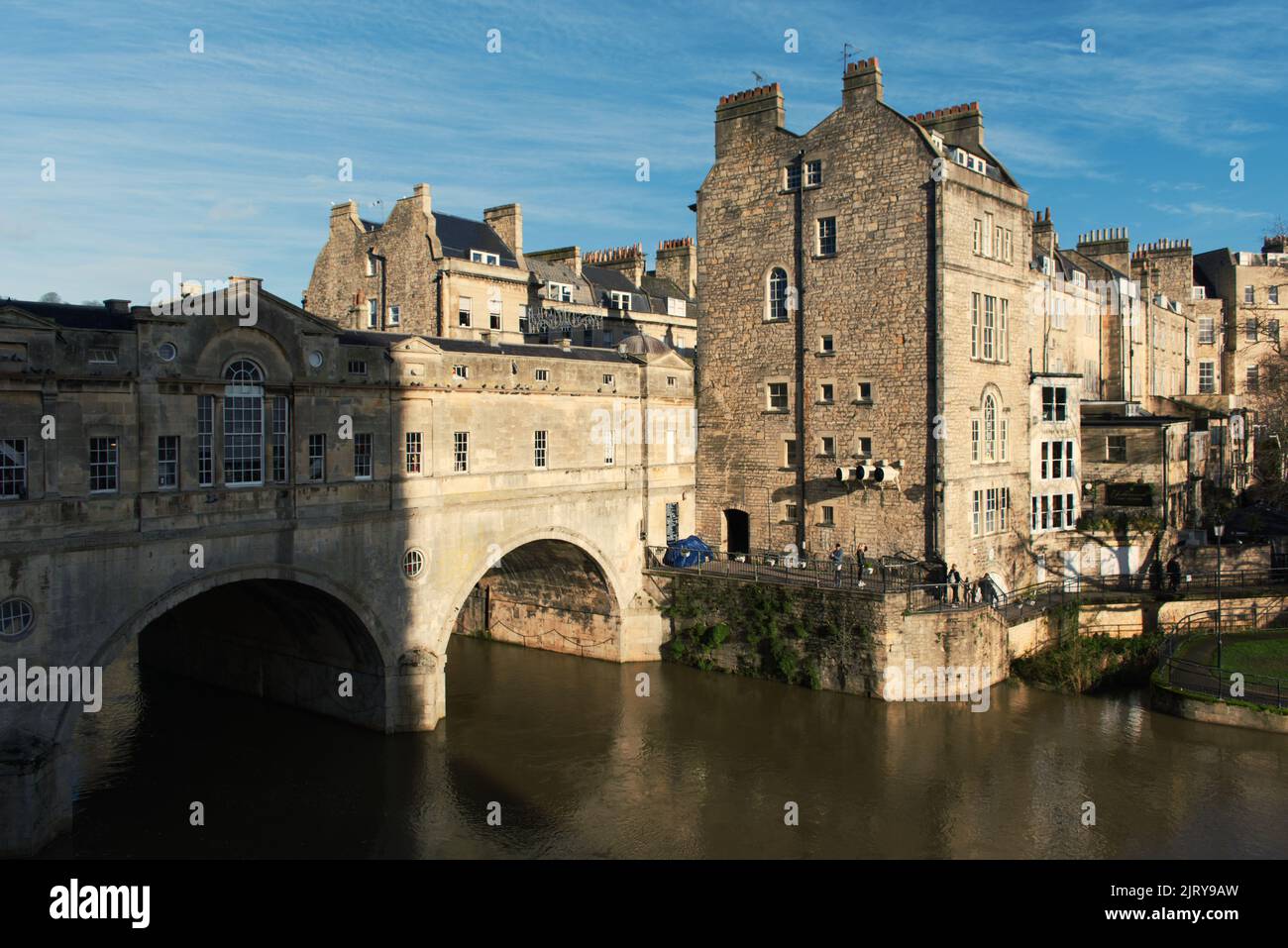An outdoor view of the old building and Pulteney Bridge over a river in ...