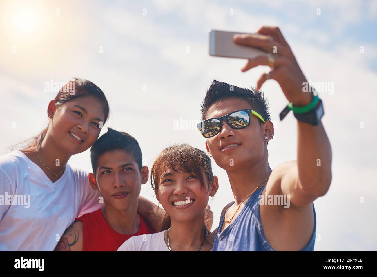 Make memories with friends. a group of smiling friends taking a selfie ...