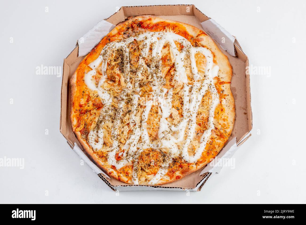 Round chicken pizza with catupiry cheese on a white table. Very common ...