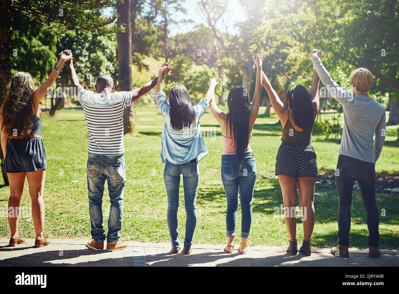 Together were unstoppable. Rearview shot of a group of young friends ...