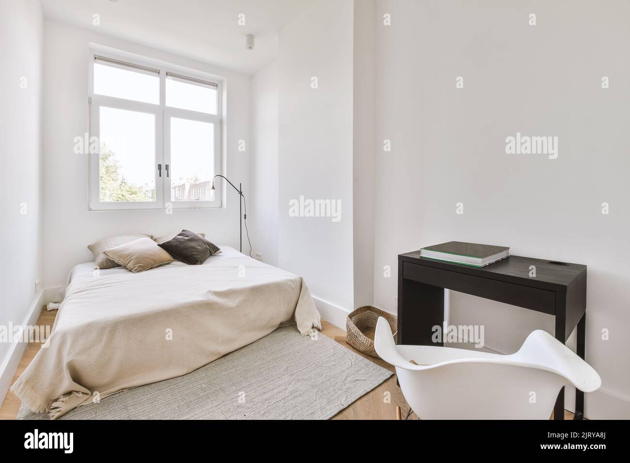 Home interior design of bedroom with bed and wooden wardrobe placed in ...