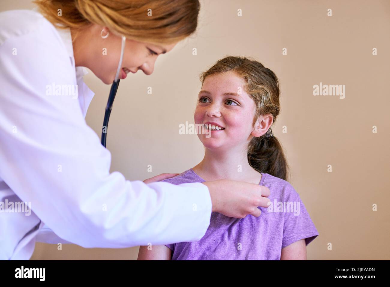 Lets take a listen to your heart. a pediatrician examining a little ...