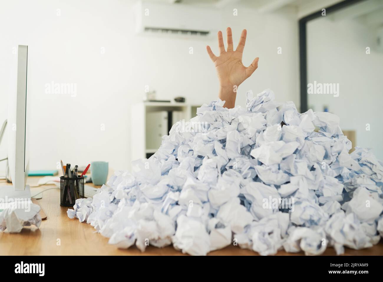 Admin can be overwhelming once it piles up. an unidentifiable businesswoman drowning under a ...