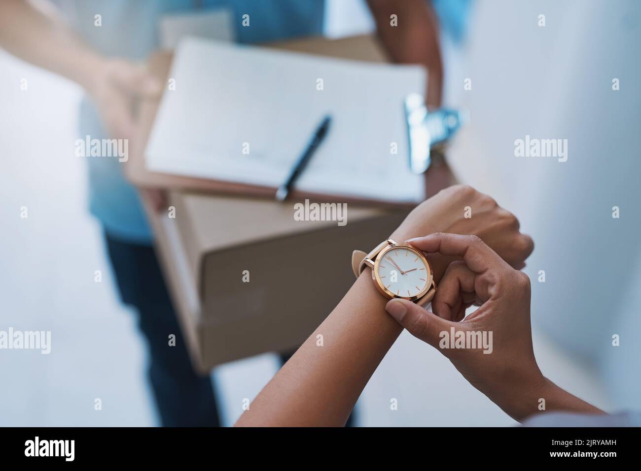 Right on time. an unidentifiable businesswoman checking the time on her ...