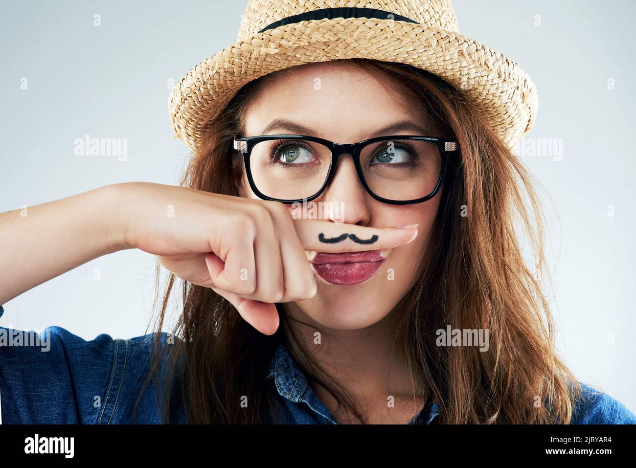 They said life would be better with a moustache. Studio shot of a young ...