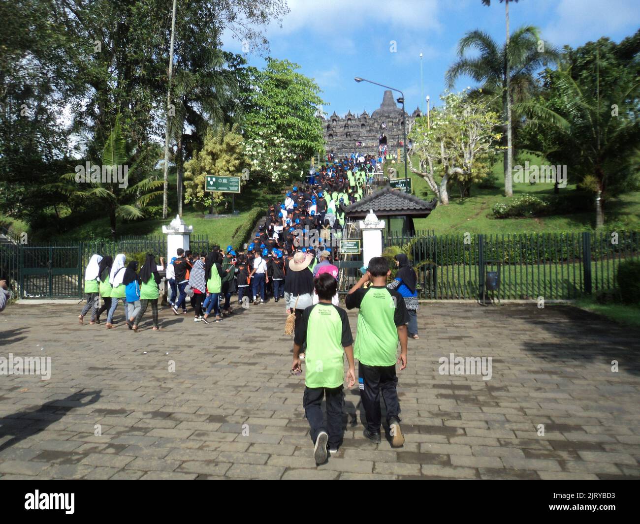 A group of Indonesian students are walking towards Borobudur temple ...