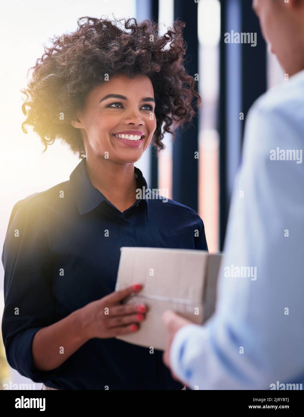 You got here just in time. a happy businesswoman accepting a package ...