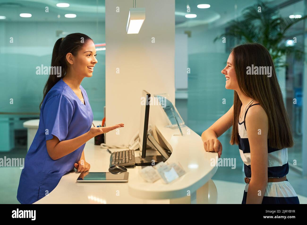 What ails you today. a young nurse assisting a patient at the reception ...