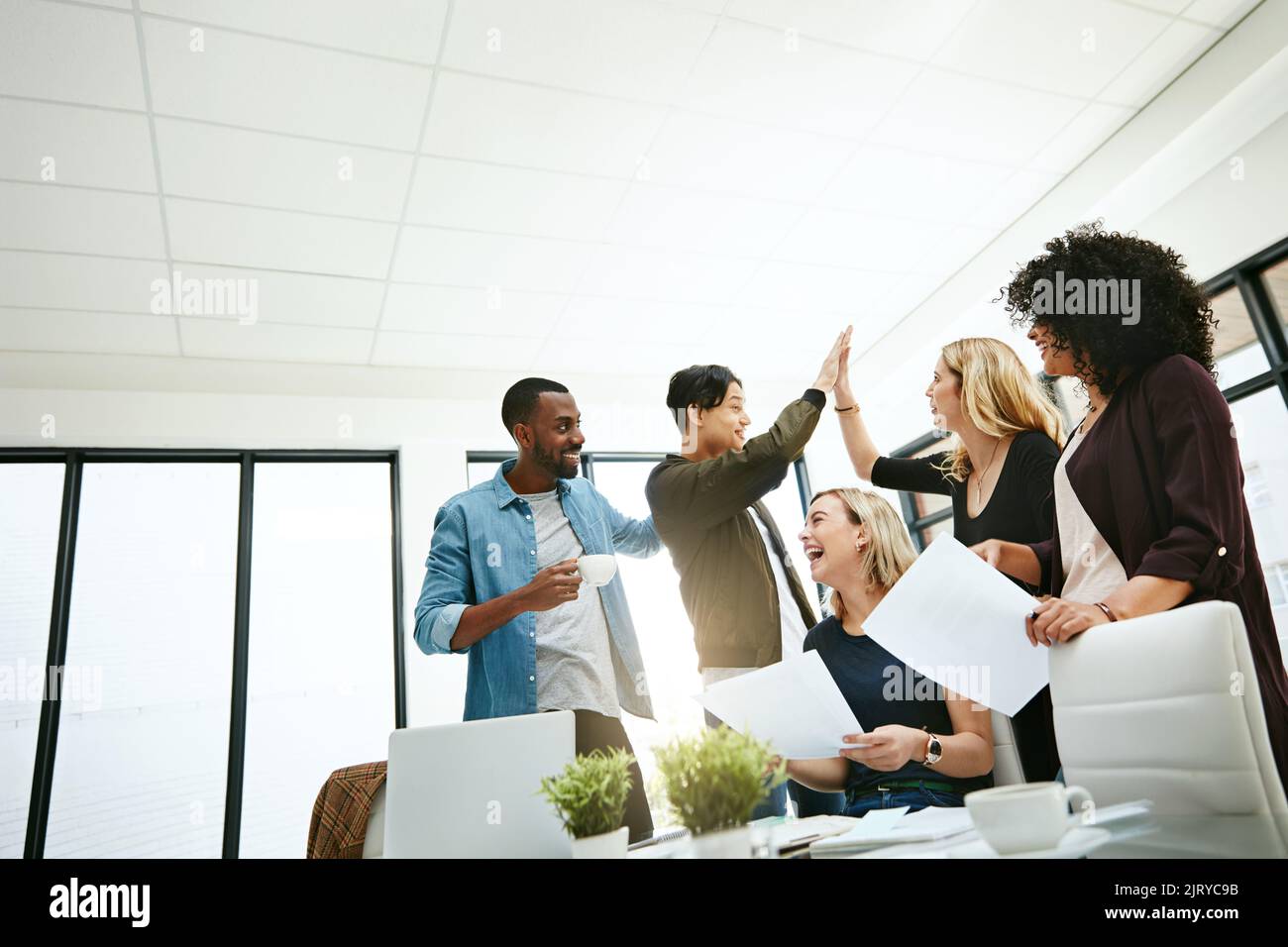 Working with a positive team has many perks. colleagues celebrating ...