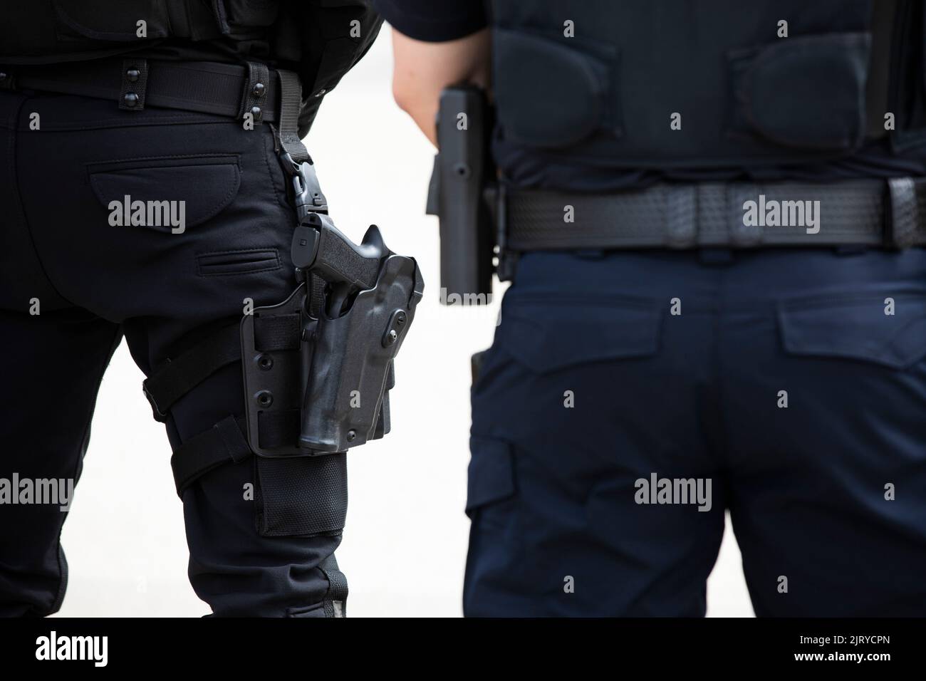 Daytime view of a white police officer's utility belt and gun holster ...