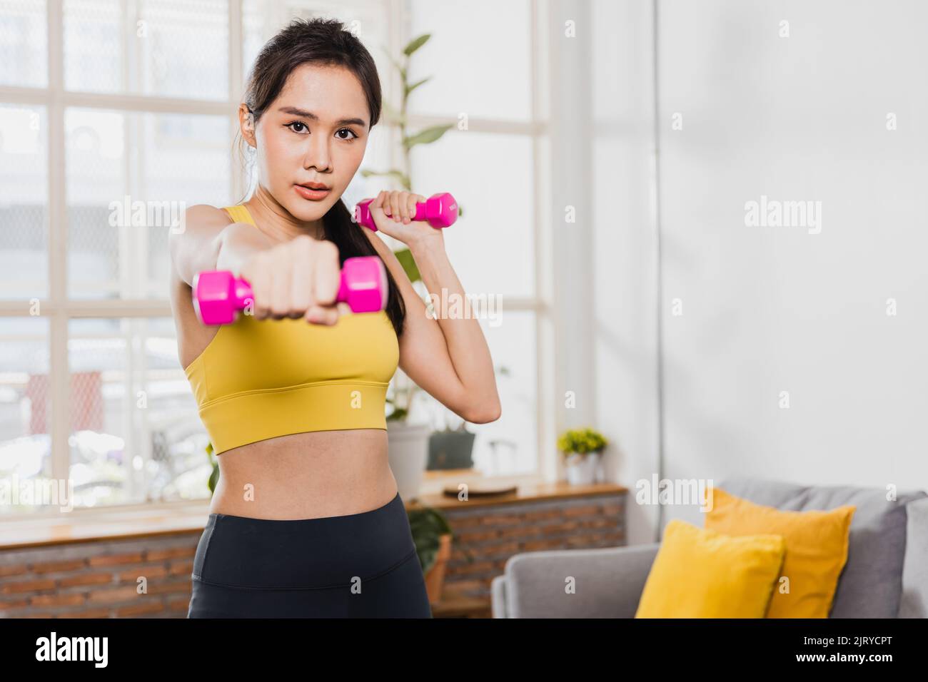 Asian beautiful woman in sport wear exercise and work out at home with ...