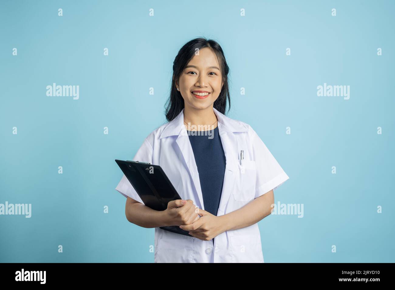 Portrait beautiful Asian doctor smiled and holding document folder blue ...