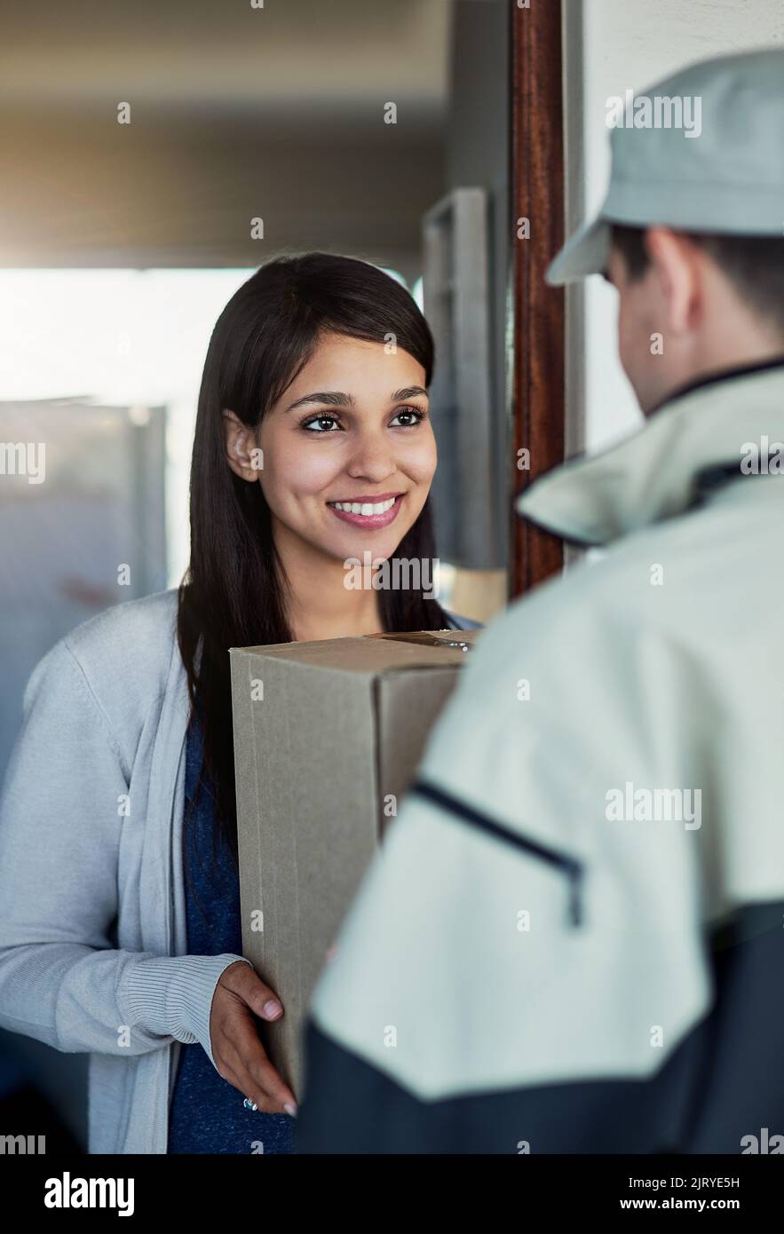 Fast and friendly service gets her smiling. a young woman receiving her ...