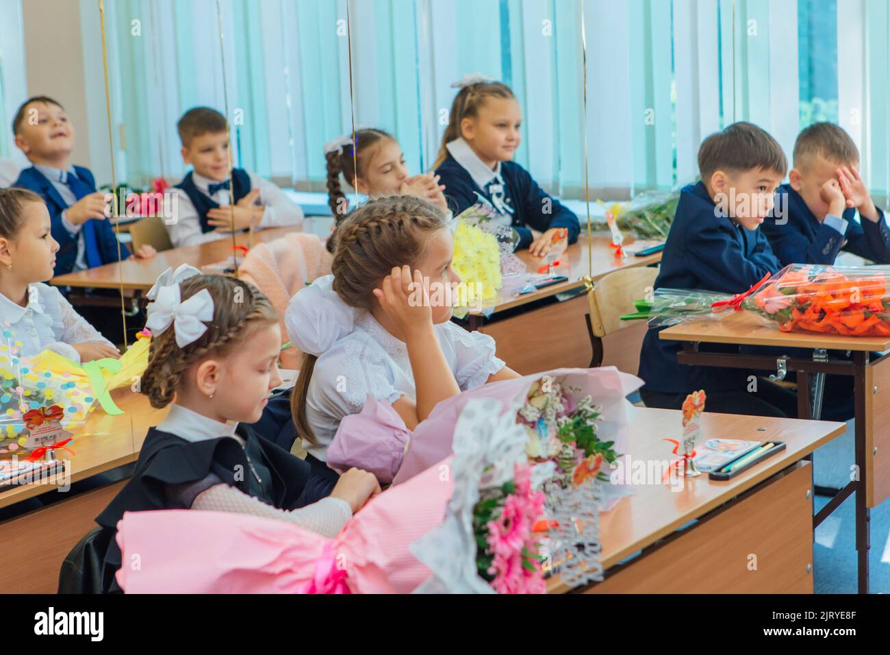 First-grade students and teacher are in school classroom at first ...