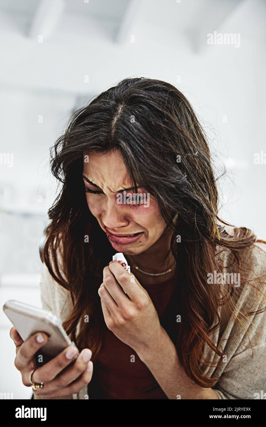 Can you come get me. a beaten and bruised young woman crying while ...