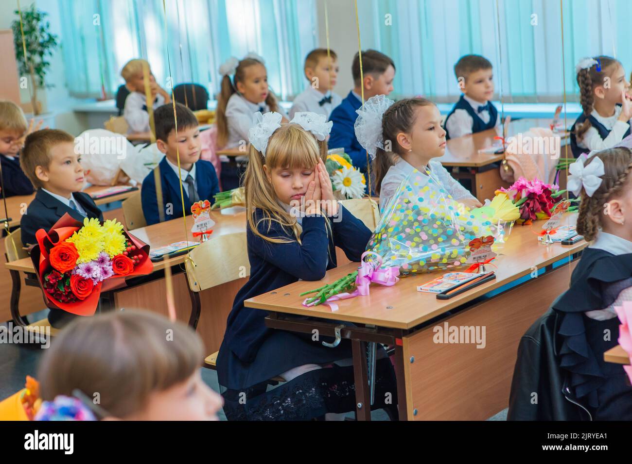 First-grade students and teacher are in school classroom at first ...