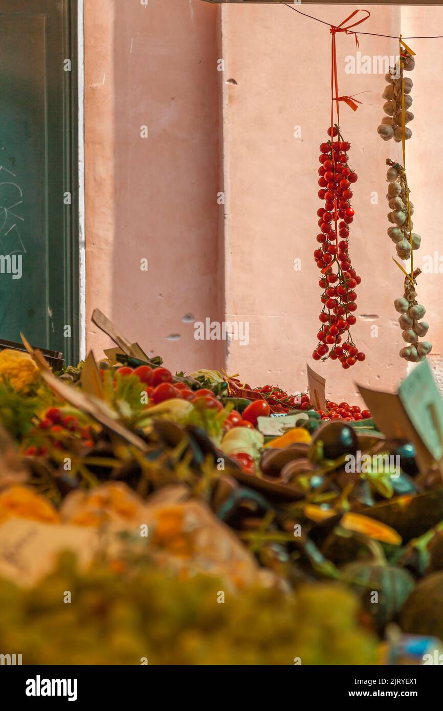 Vegetable stall, market stall with vegetables, garlic plait and strung ...