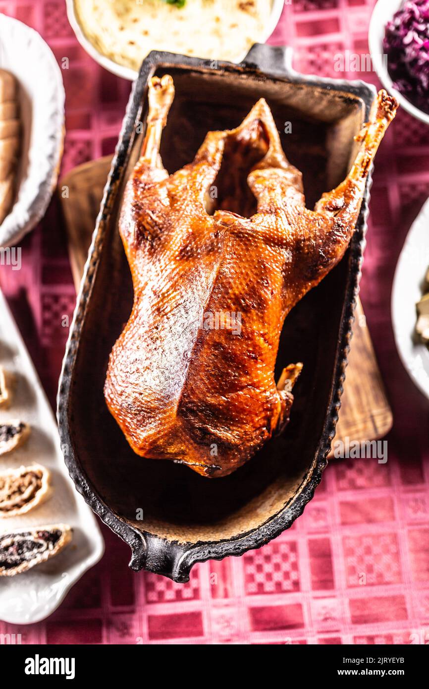 Crispy baked goose in an original baking dish on the festive table ...