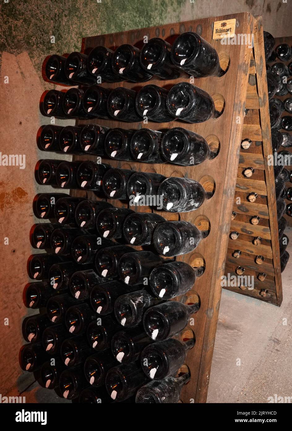 : Champagne bottles in pupitre, Ruinart champagne cellar in Reims ...