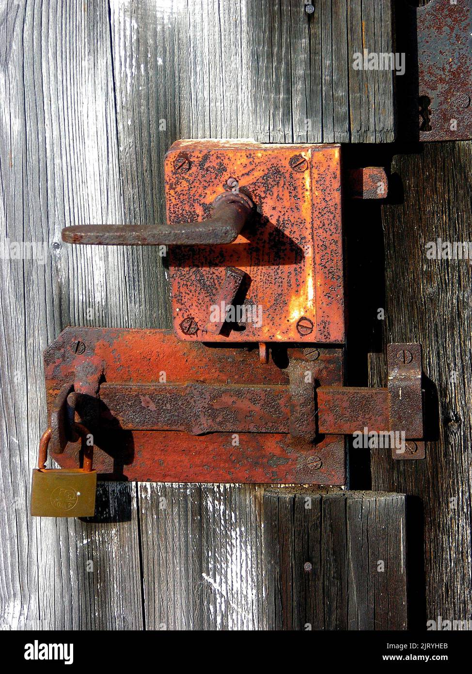 Old rusty door lock on wooden gate Stock Photo - Alamy