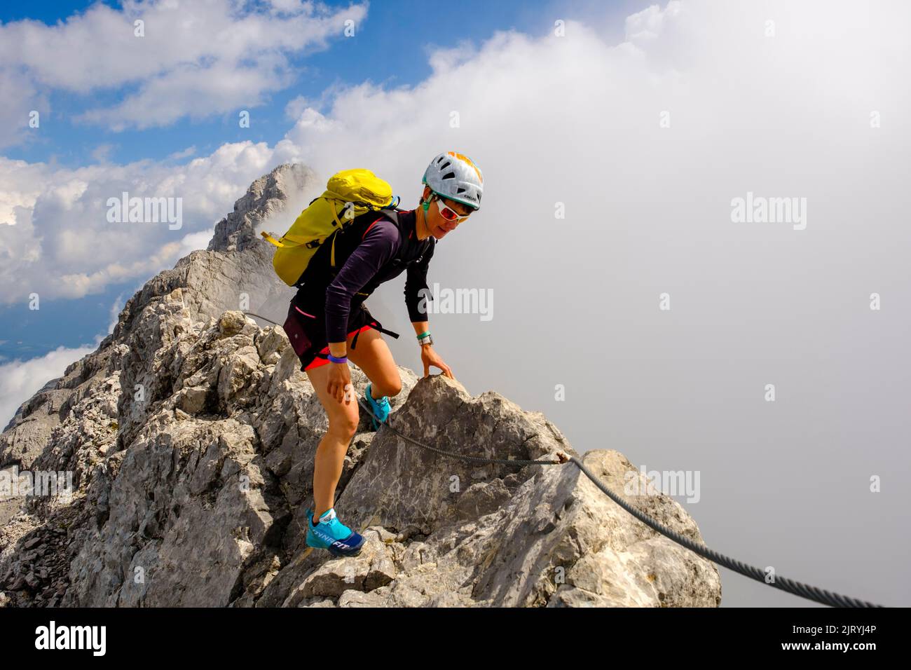 Mountaineer climbing on the Watzmann ridge, in the back the middle peak ...