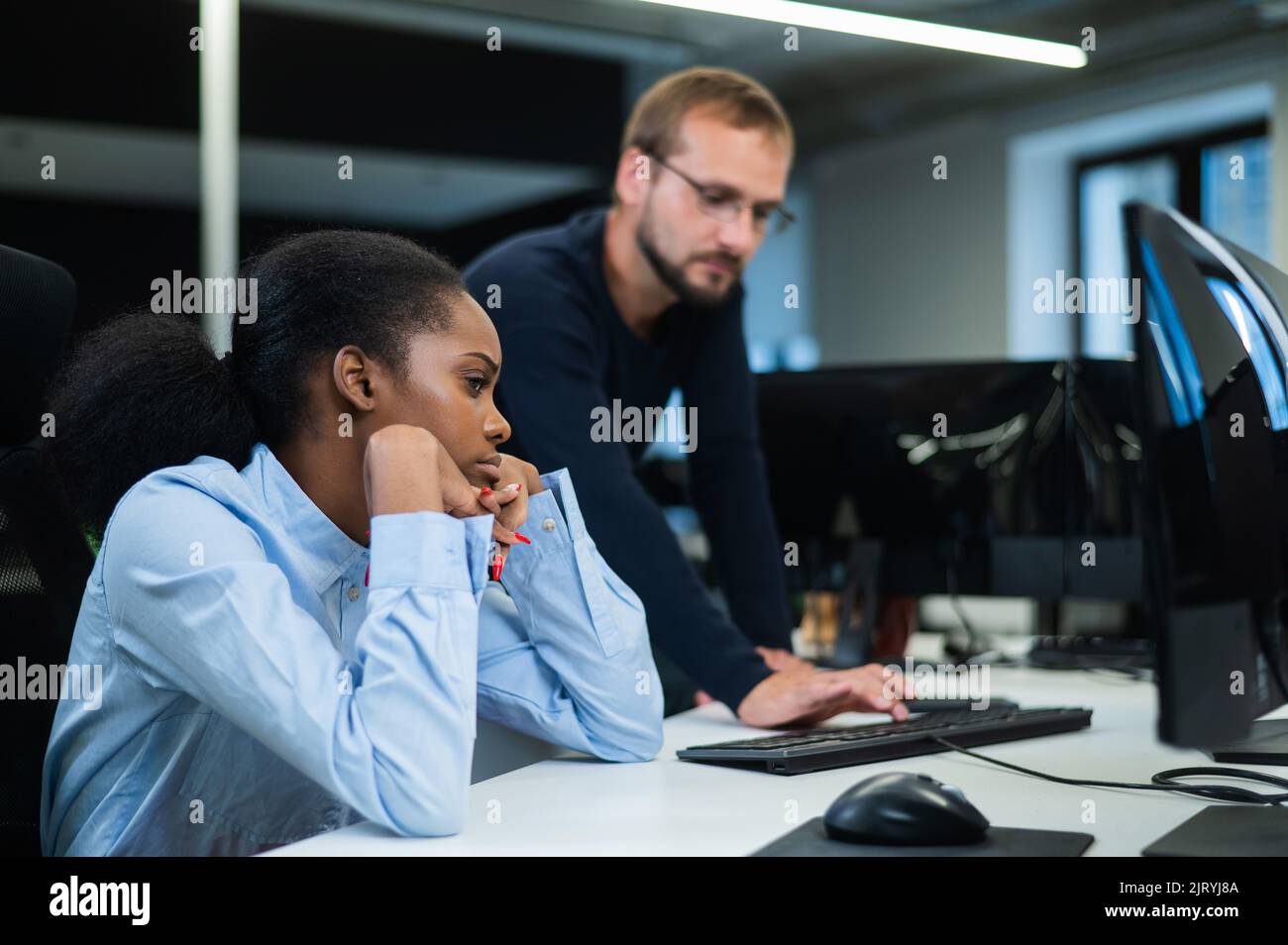 Colleagues look at the monitor and decide working moments. Caucasian ...