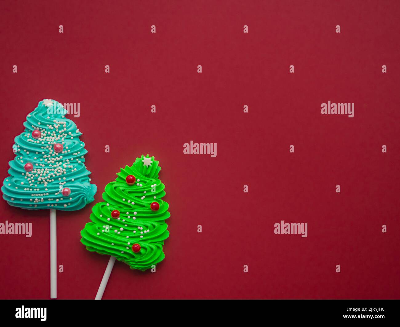 Green and blue candies in the form of a Christmas tree on a red ...