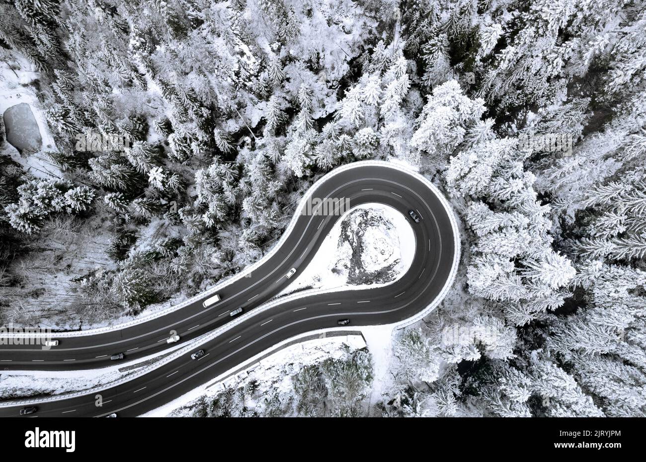Aerial view of a narrow curve with rocks in the middle, winter, Black ...