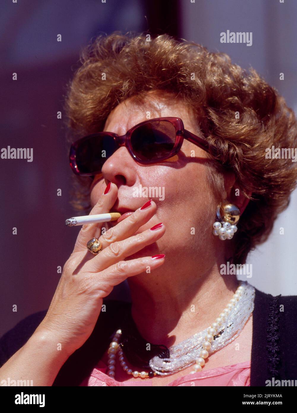 Elderly woman smoking cigarette Stock Photo - Alamy
