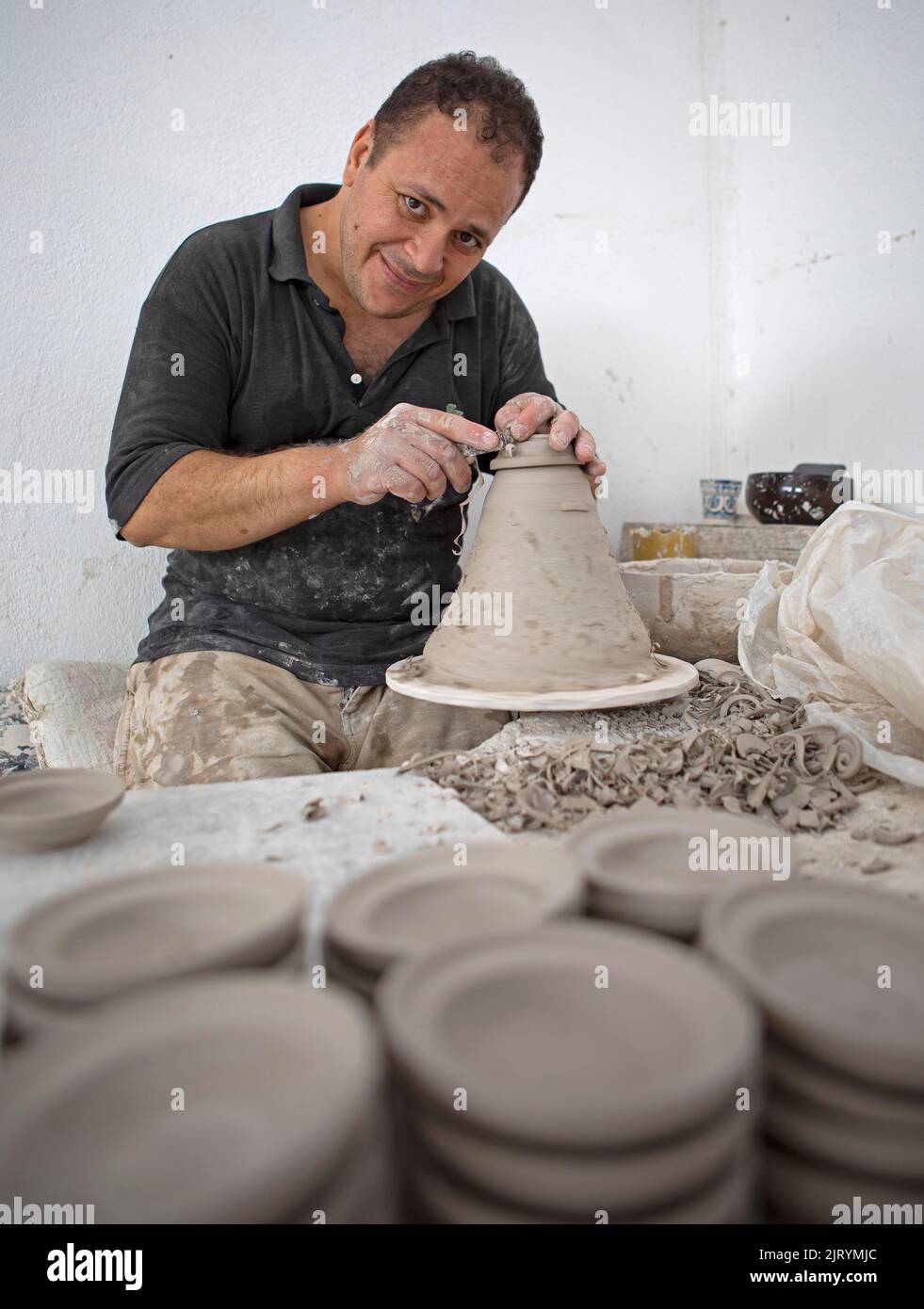 Moroccan potter at work: turning at the potter's pane and shaping ...