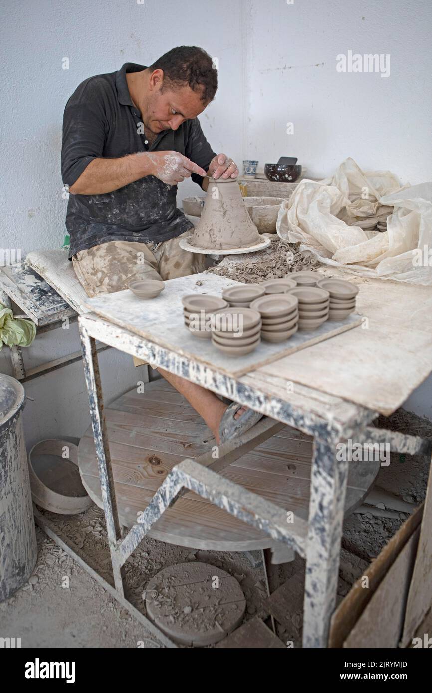 Moroccan potter at work: turning at the potter's pane and shaping ...
