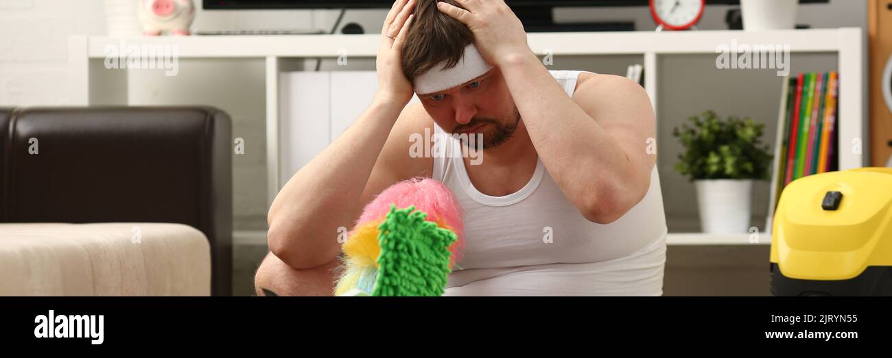 Sad lonely man is cleaning house. Bachelor life of men concept Stock ...