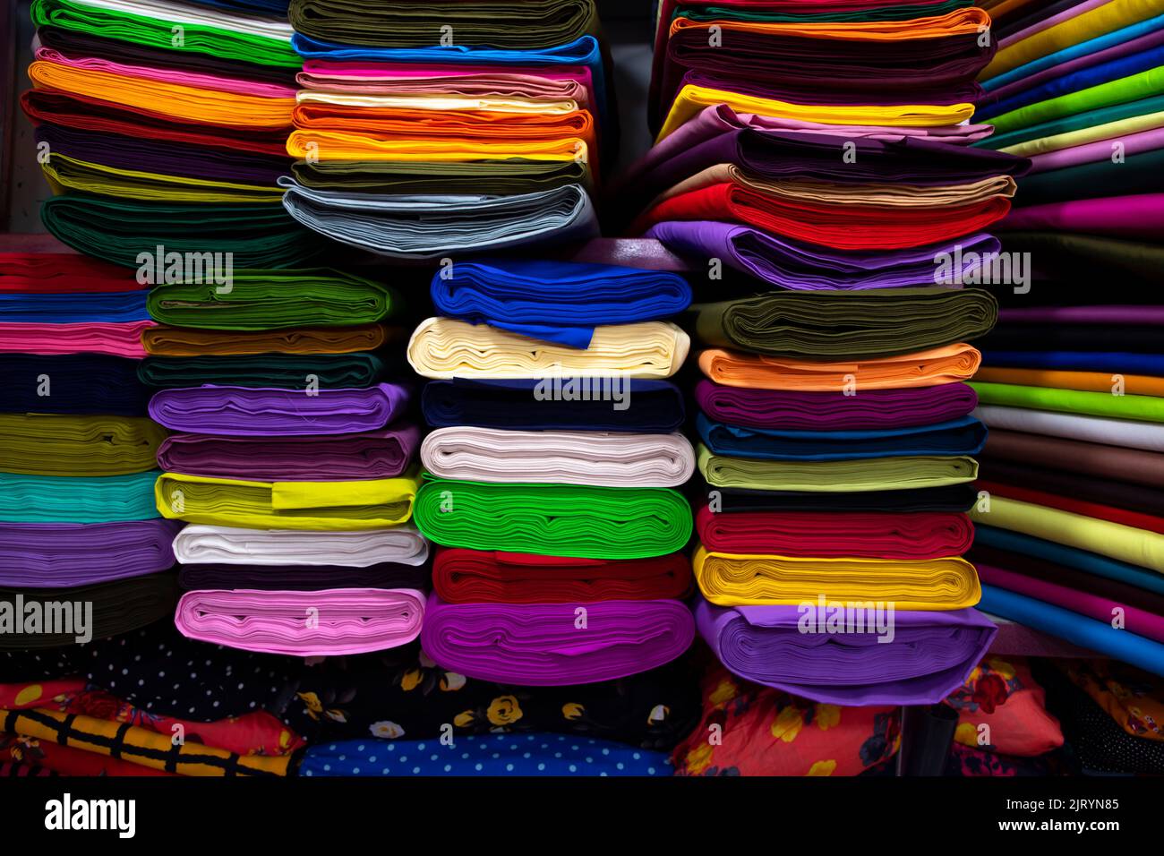 Artistic variety shade tone colors Textile Fabrics stacked on retail ...