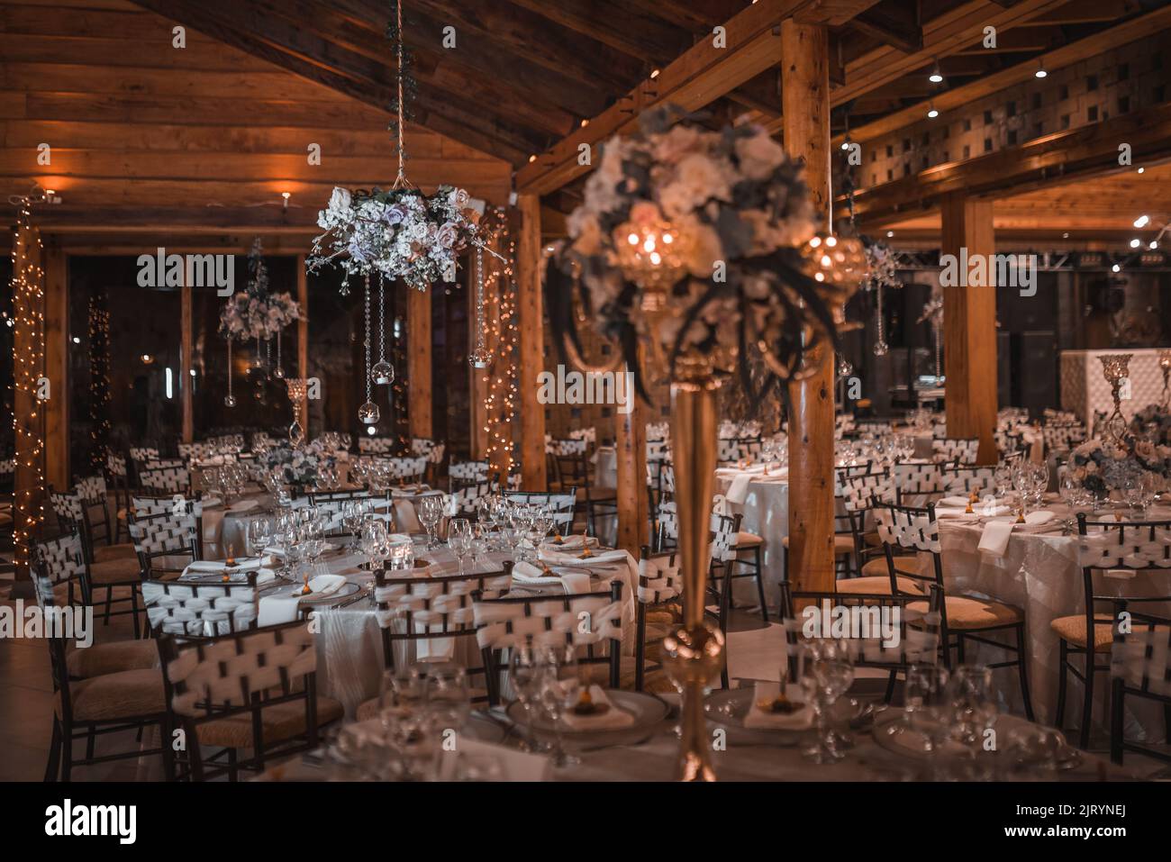 A wooden interior of a classy restaurant with floral decorations Stock ...