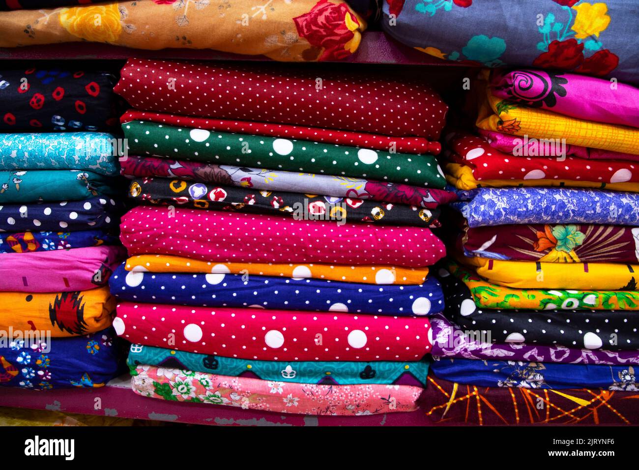 Artistic variety shade tone colors Textile Fabrics stacked on retail ...