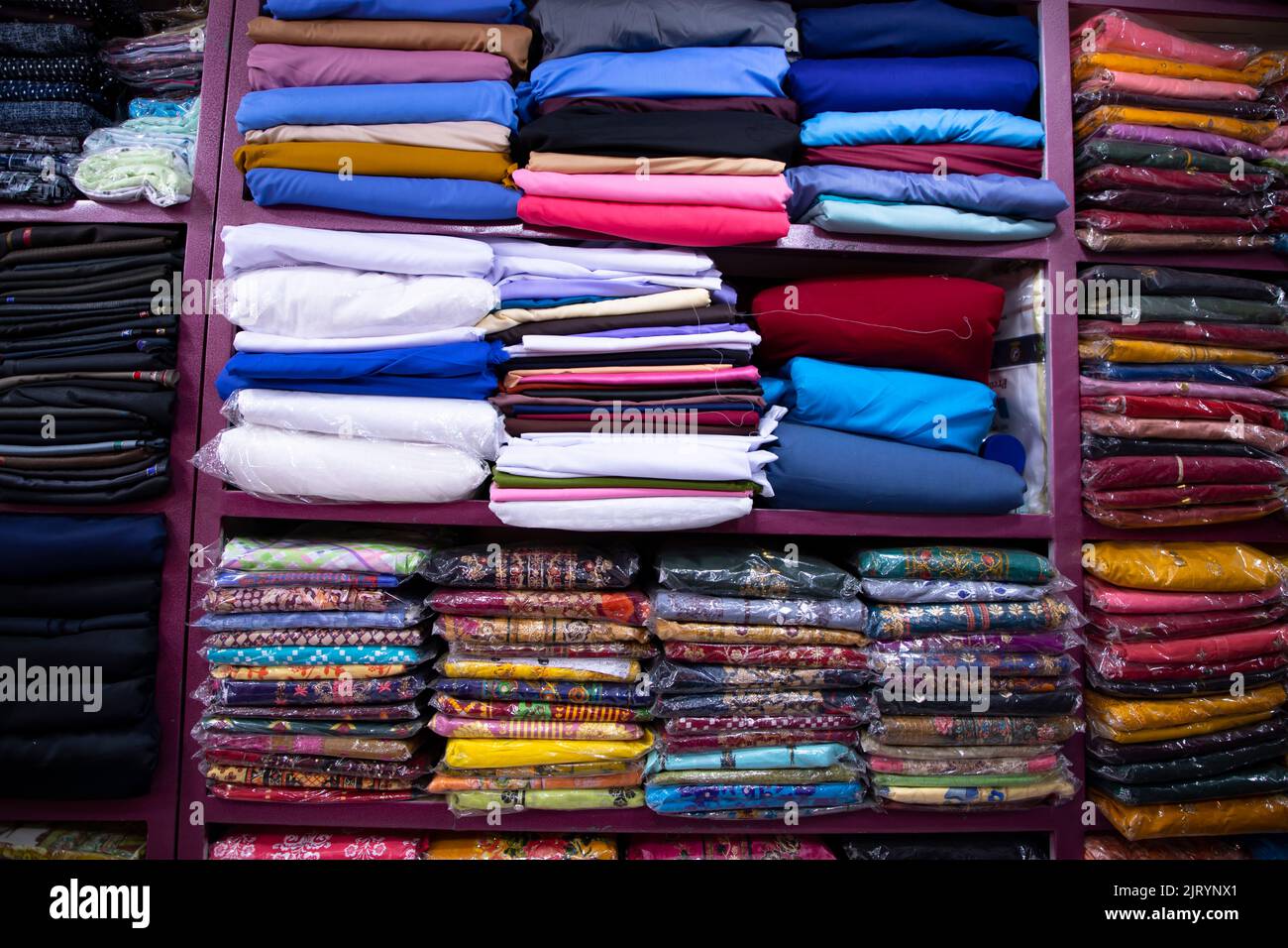 Patterned Textile Fabrics stacked on a retail Shop Shelf for sale Stock ...