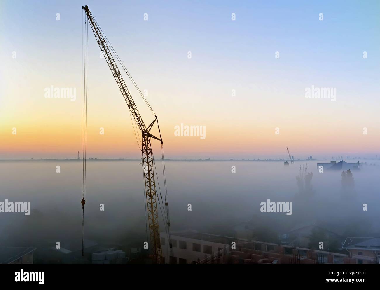 Crane silhouette and Koblevo skyline in the morning mist, Ukraine Stock ...