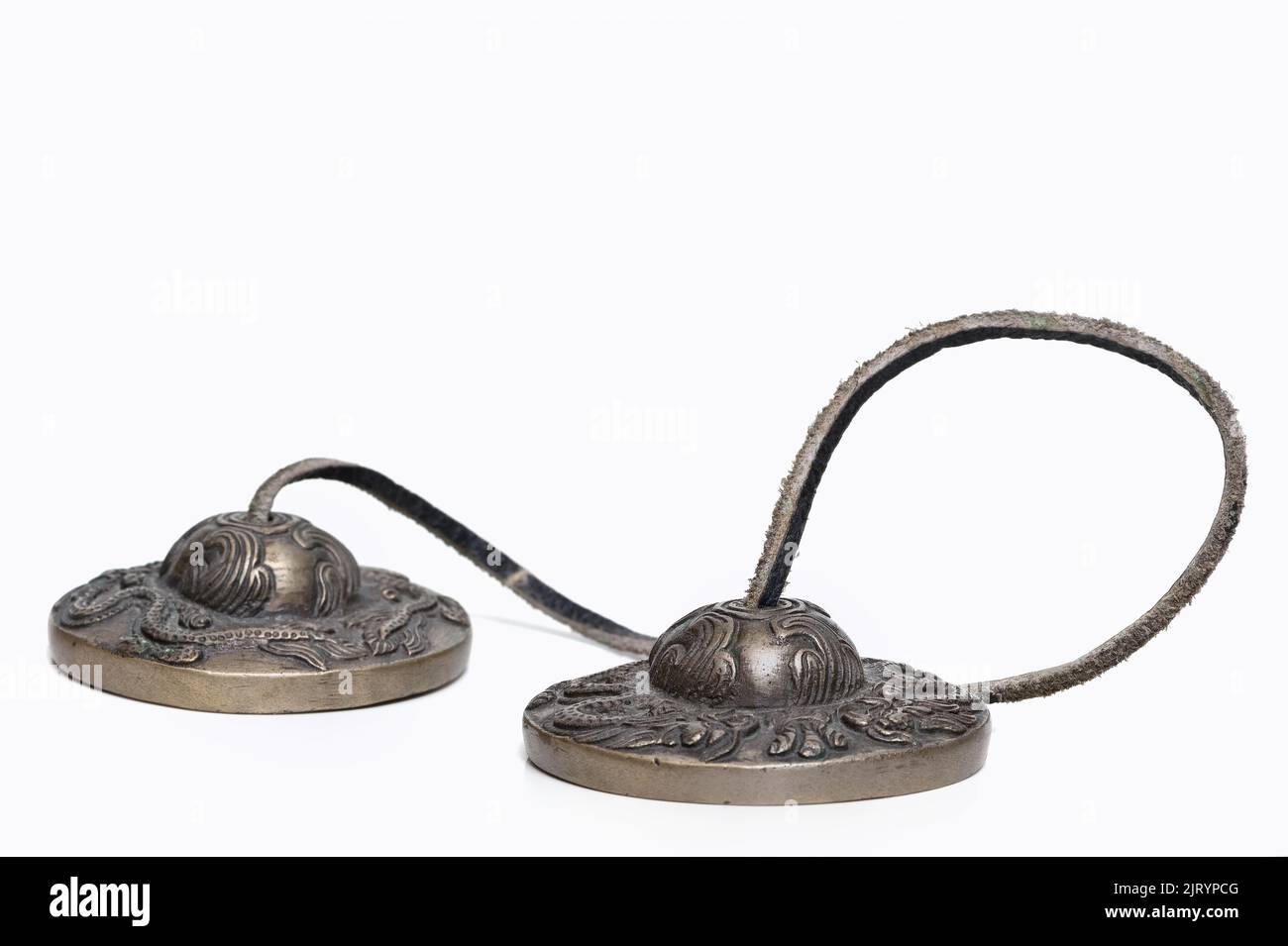 Tibetan Buddhist tingsha cymbals isolated Stock Photo - Alamy