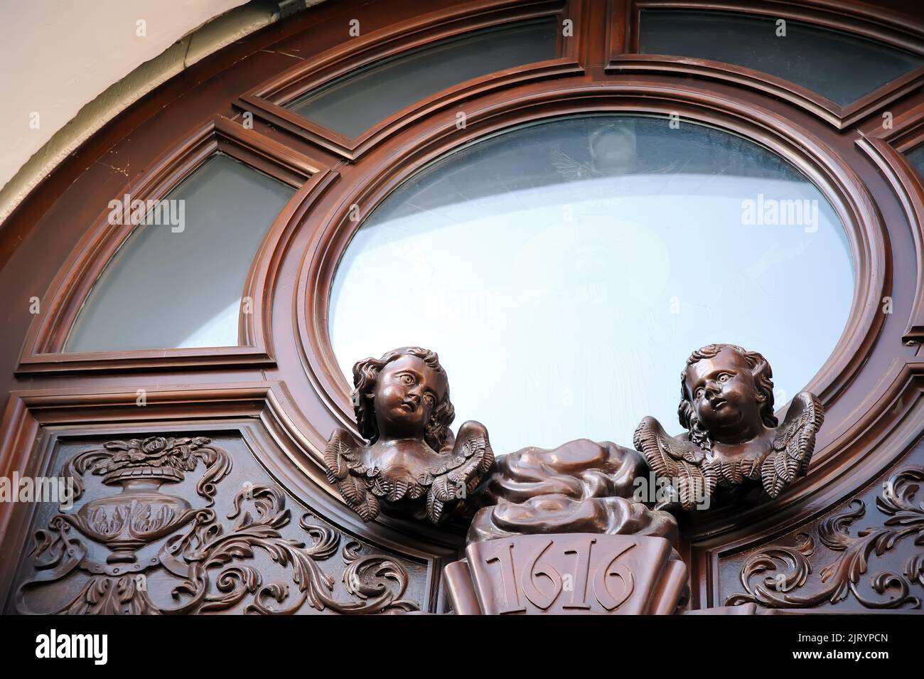 Round window wooden frame with angels figures Stock Photo - Alamy