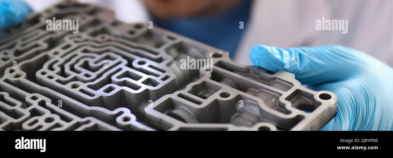 Car repair mechanic holds automatic transmission in hands Stock Photo ...