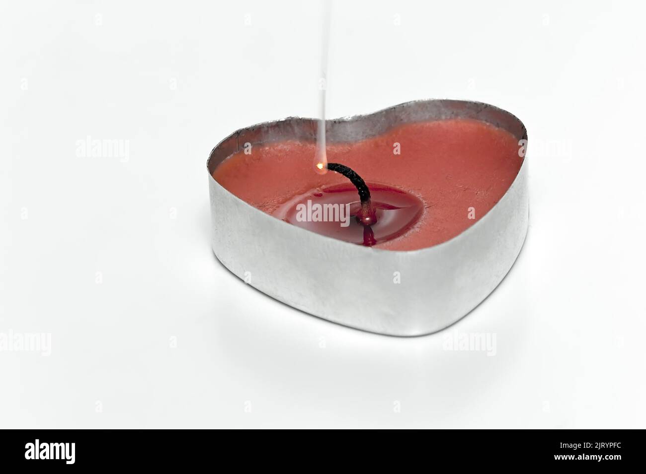 The small dimmed candle in the shape of heart isolated Stock Photo - Alamy