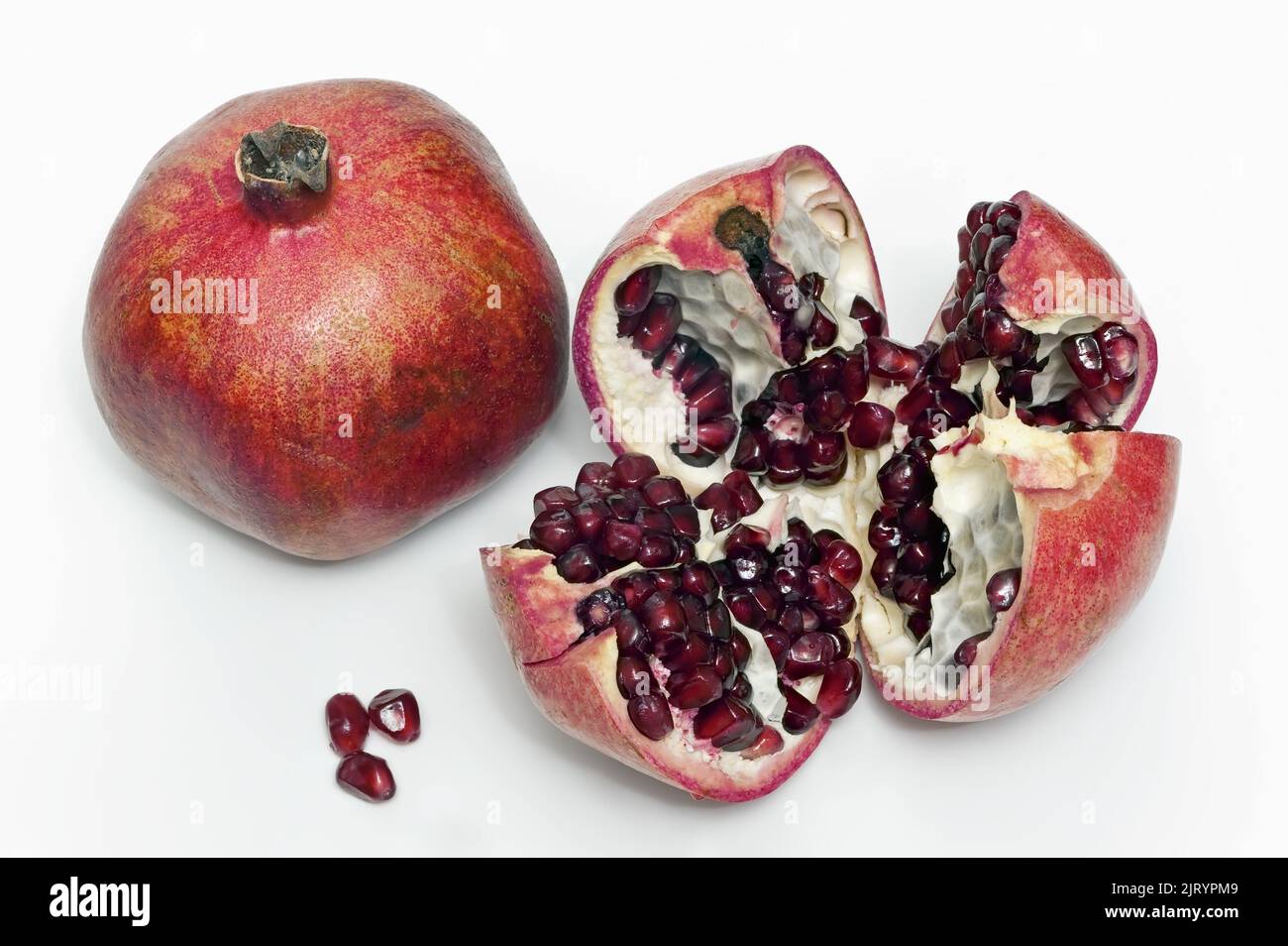 The closeup view of two pomegranates, the whole and split Stock Photo ...