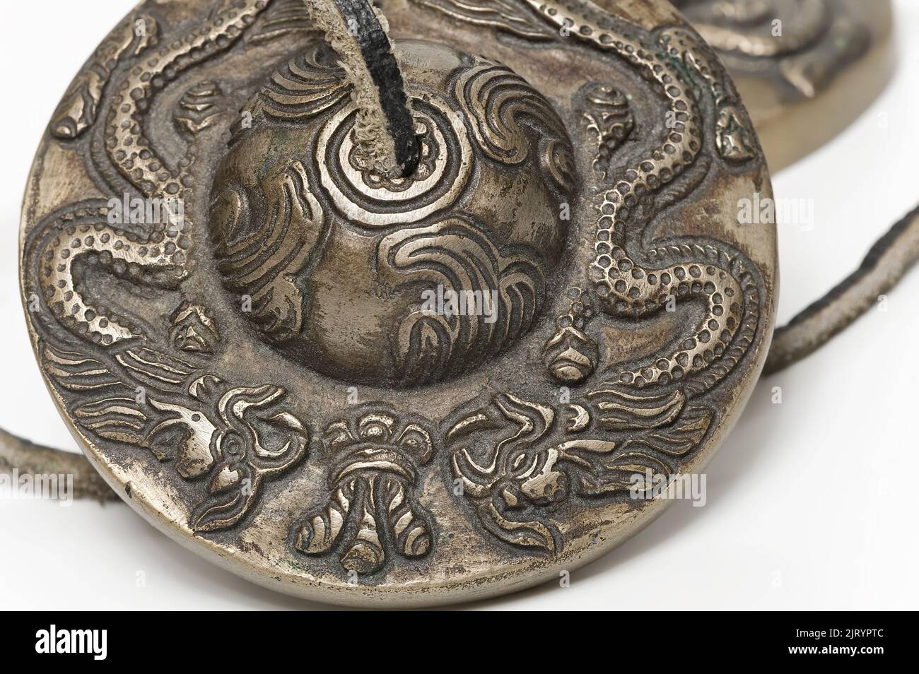 Tibetan Buddhist tingsha cymbal dragons ornament isolated Stock Photo ...