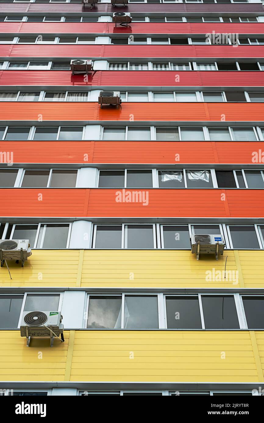 Multicoloured high-rise apartment facade. Urban real estate background ...