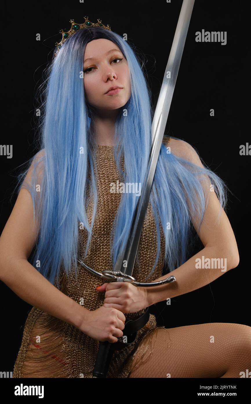 Portrait of viking woman in a traditional nordic clothes and blue wig ...