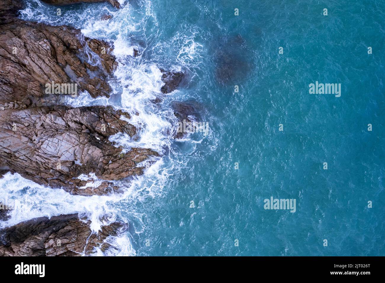 Aerial view of sea crashing waves White foaming waves on seashore rocks ...