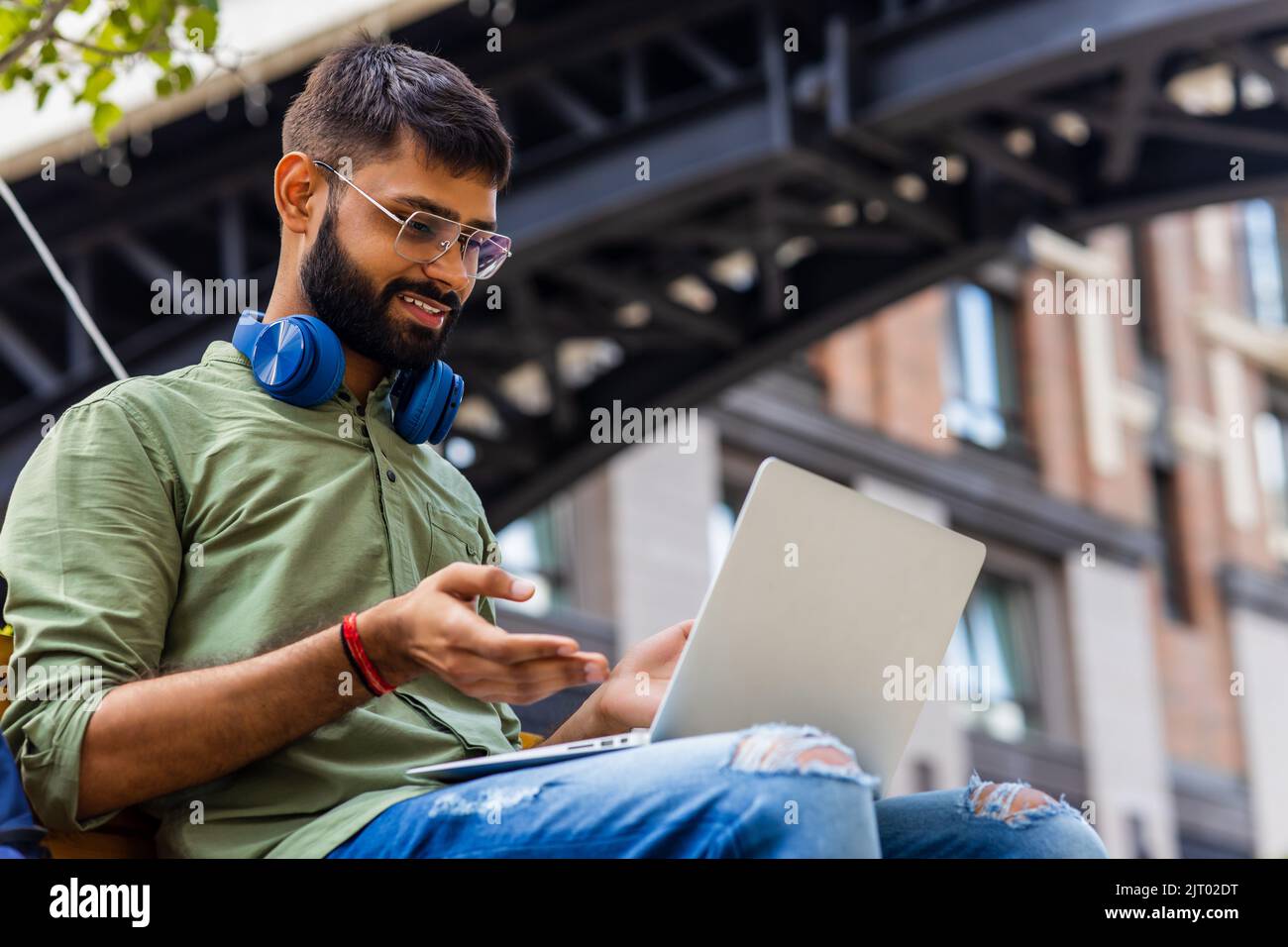 Portrait Indian student programmer using laptop computer in park Stock ...