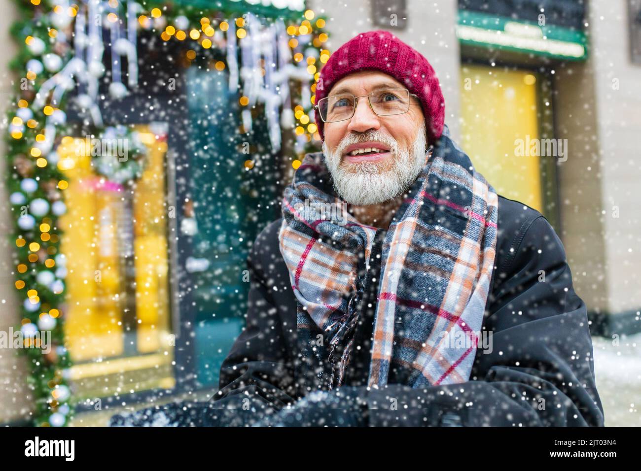 trendy old good-looking man walking in sity street at winter near ...