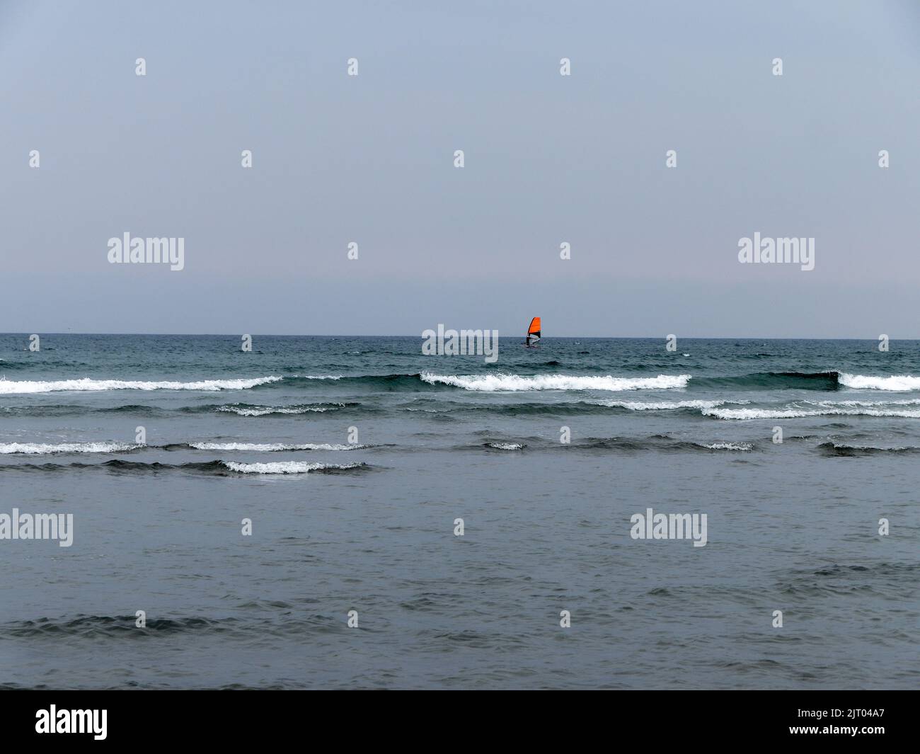 Grey overcast sky over the Cold Sea. seascape. Windsurfing. A board ...